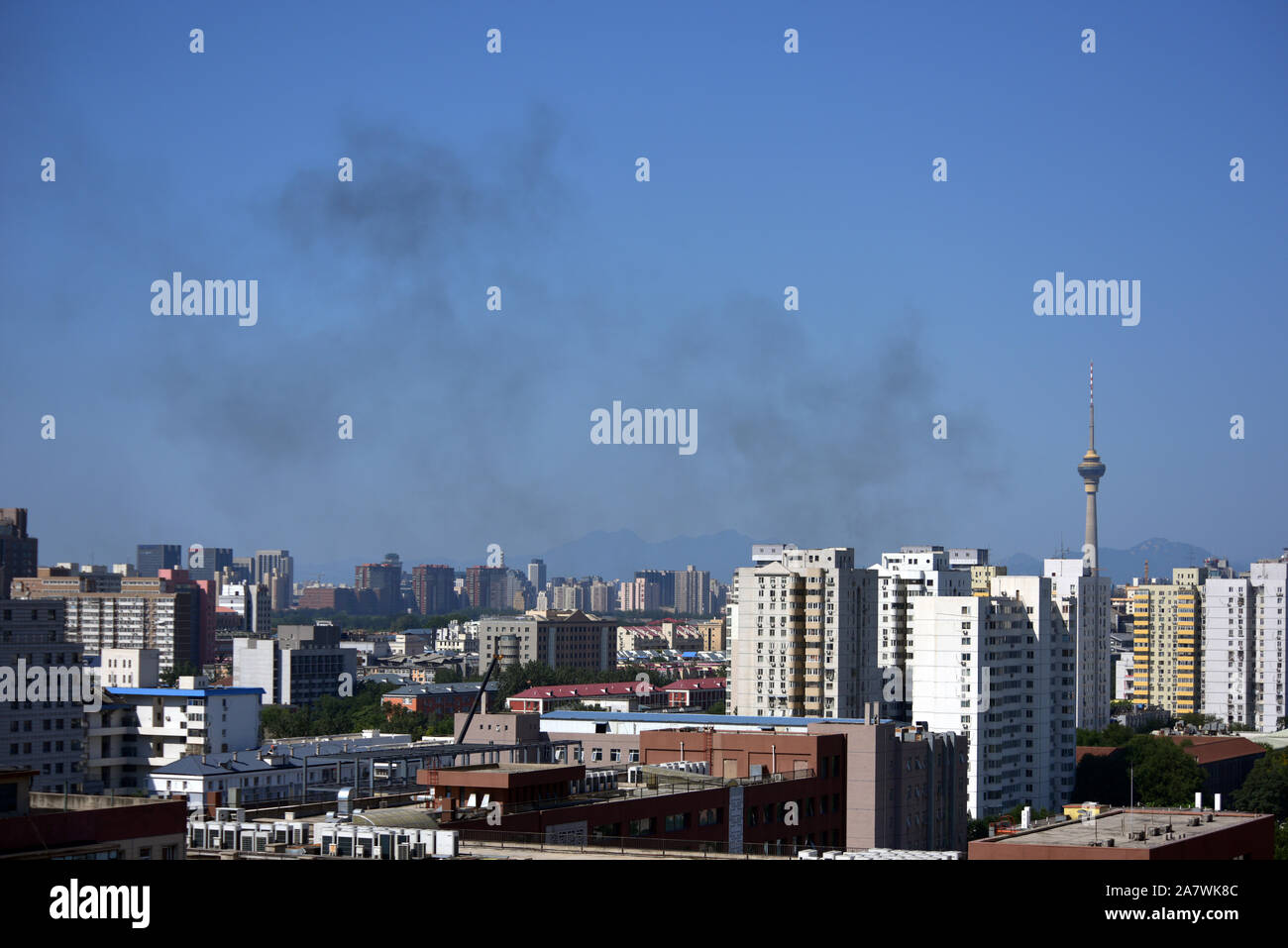 A cooling tower at the top of a two-floor building catches fire in ...