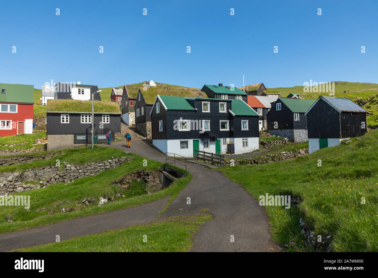 Beautiful village of Mykines with colorful houses with grass on the ...