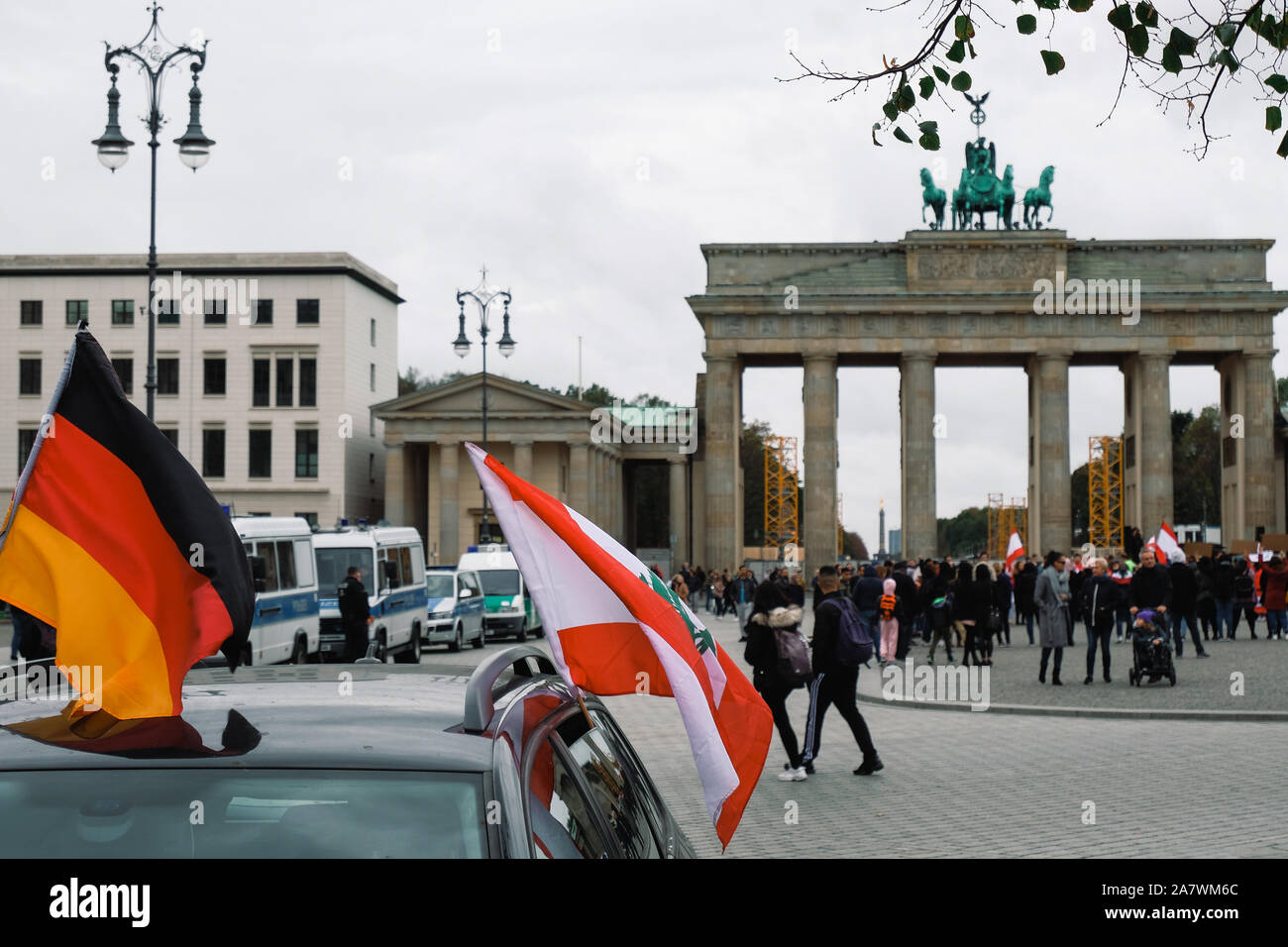 German and Lebanese flags with people protest in background,politic ...