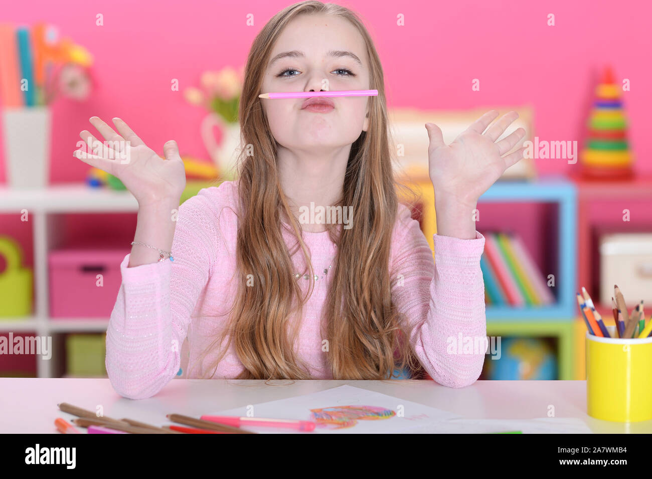Cute happy girl drawing with pencils at home Stock Photo - Alamy