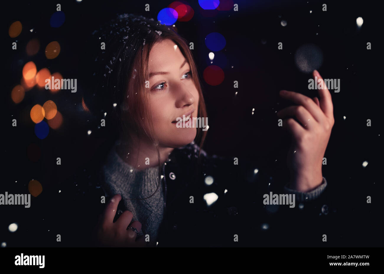 young girl outside with falling snow Stock Photo - Alamy