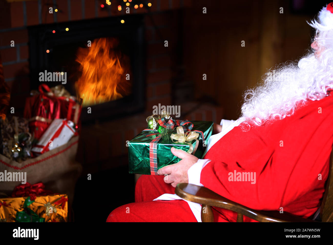 Santa claus in front fireplace hi-res stock photography and images - Alamy