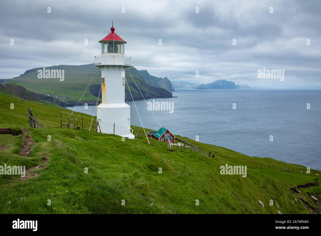 Mykines lighthouse and cliffs on Faroe islands. Hiking landmark ...
