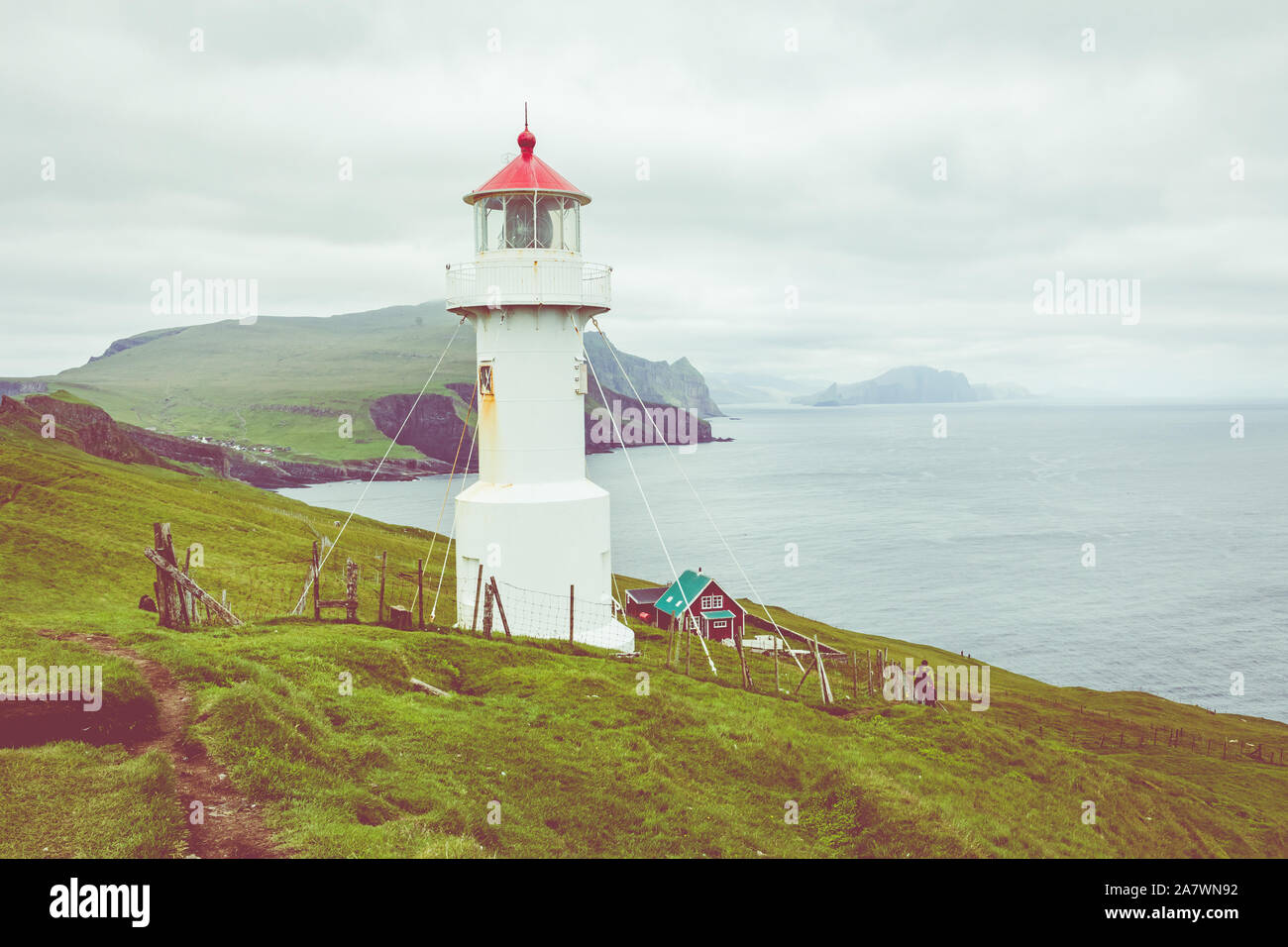 Mykines lighthouse and cliffs on Faroe islands. Hiking landmark ...