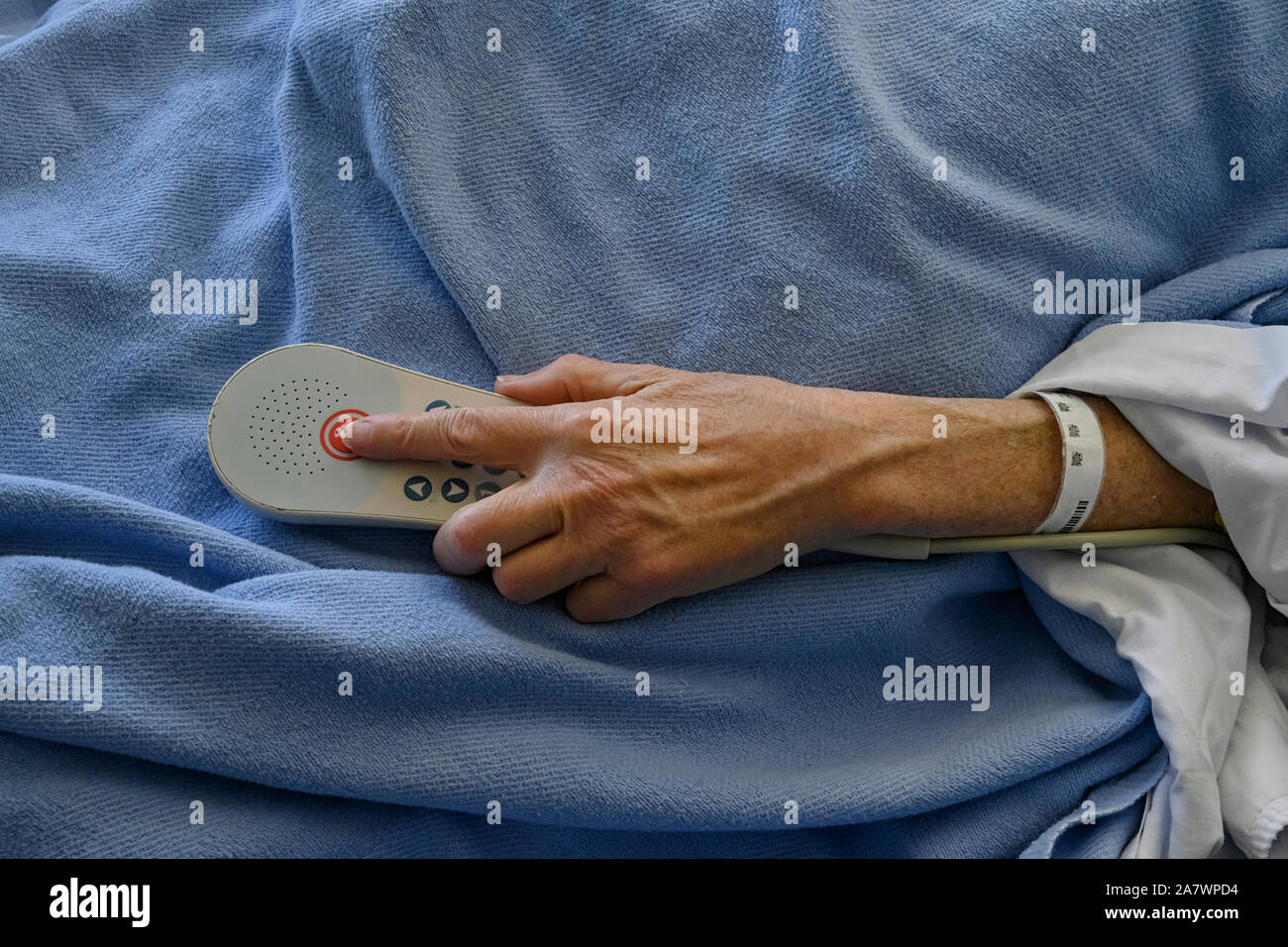Male hospital patient pressing emergency nurse call button Stock Photo ...