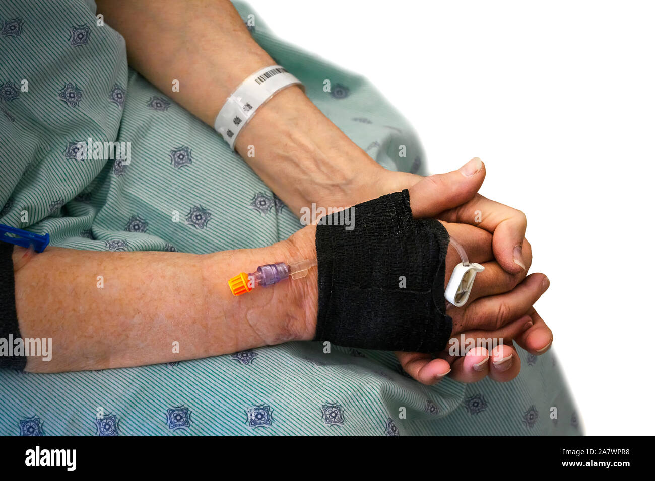 Closeup of hands of a male patient with an intravenous syringe, sitting ...