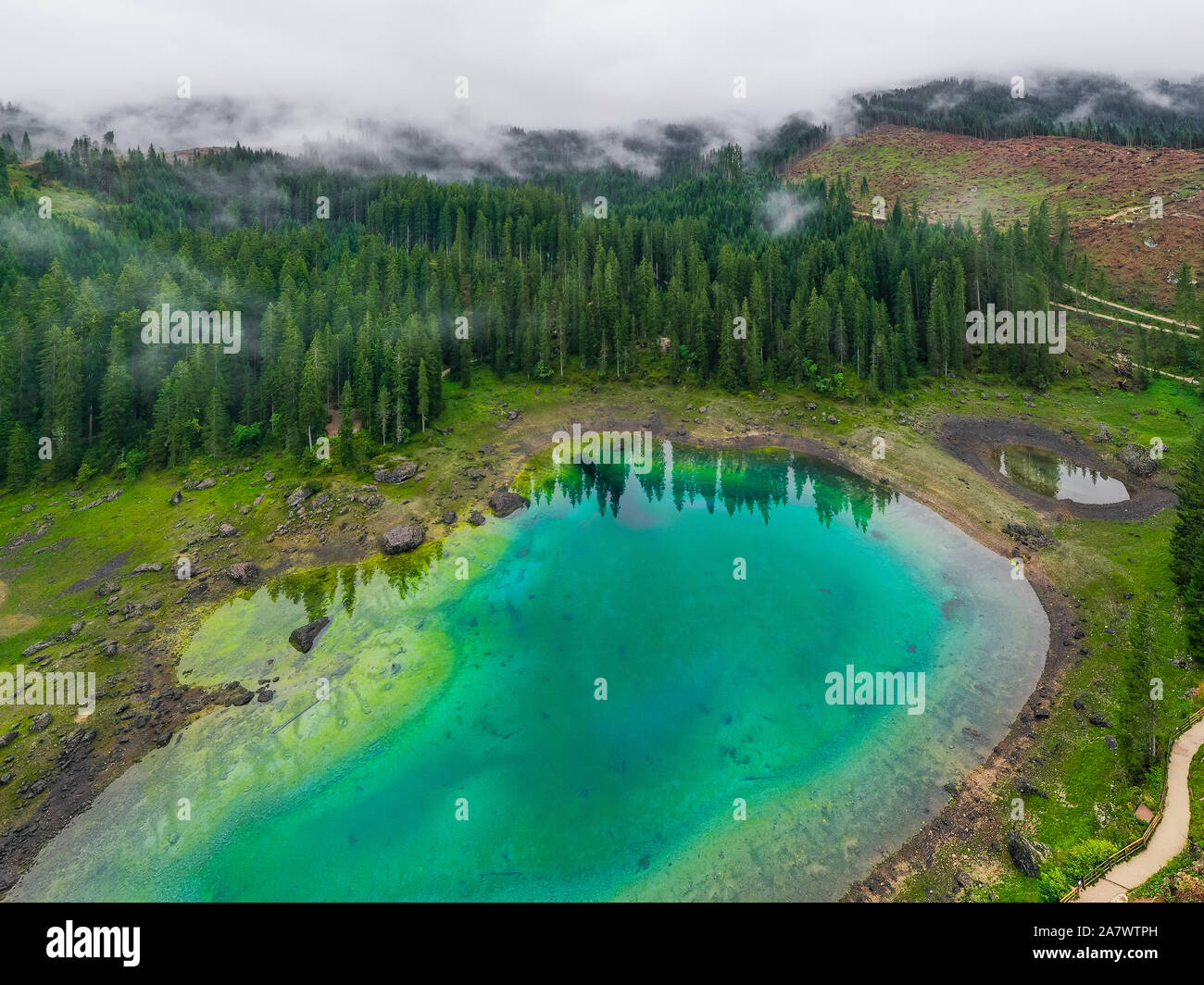 Aerial view of turquoise blue water of lake Carezza in Alps Dolomites ...