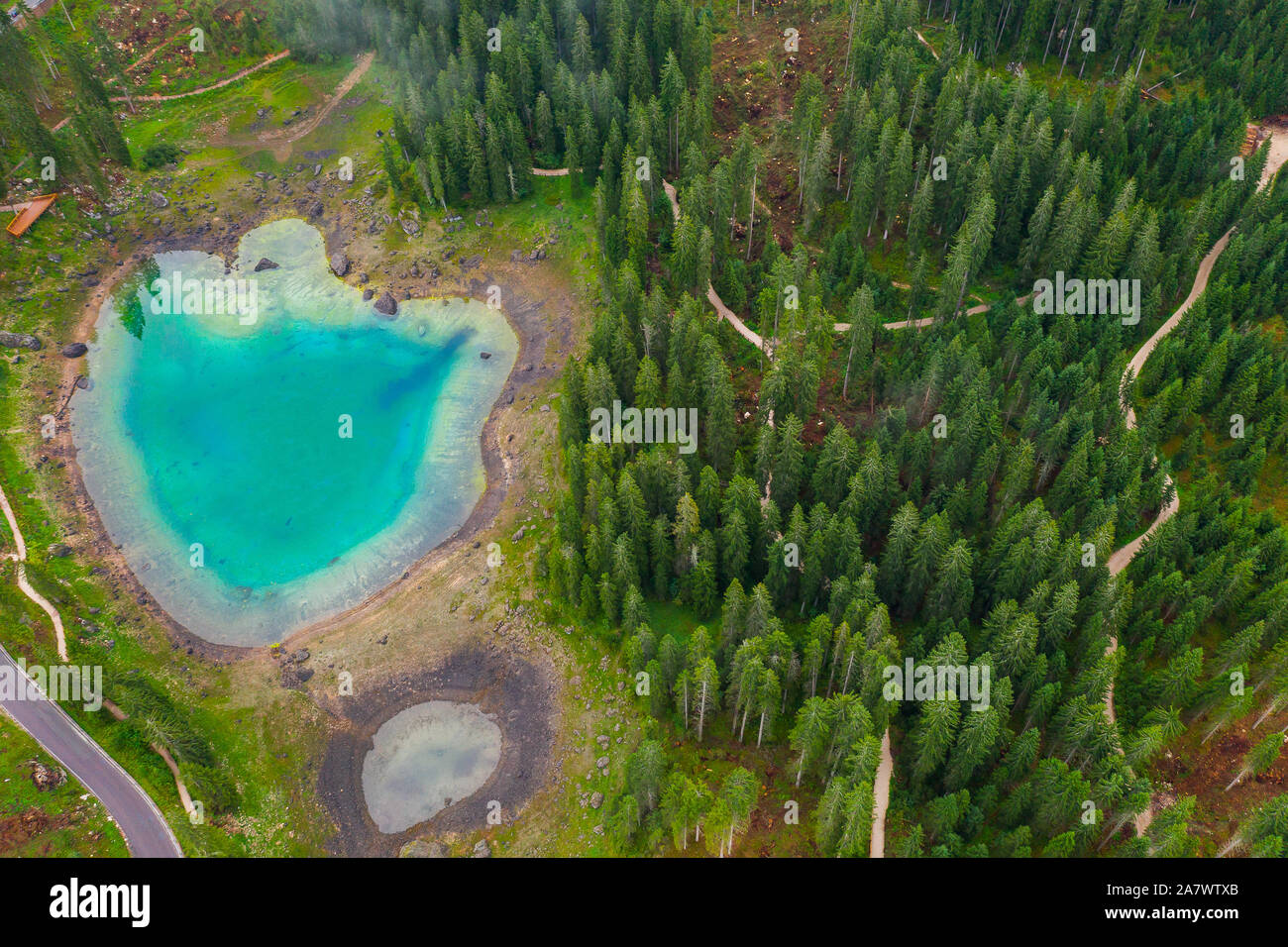 Aerial view of turquoise blue water of lake Carezza in Alps Dolomites ...