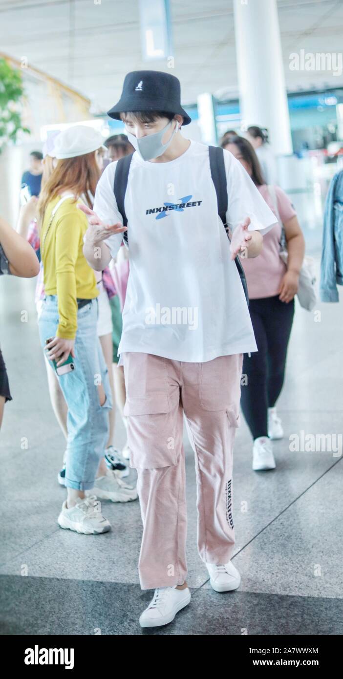 Chinese actor and singer Zhang Yuan, front white, arrives at the ...