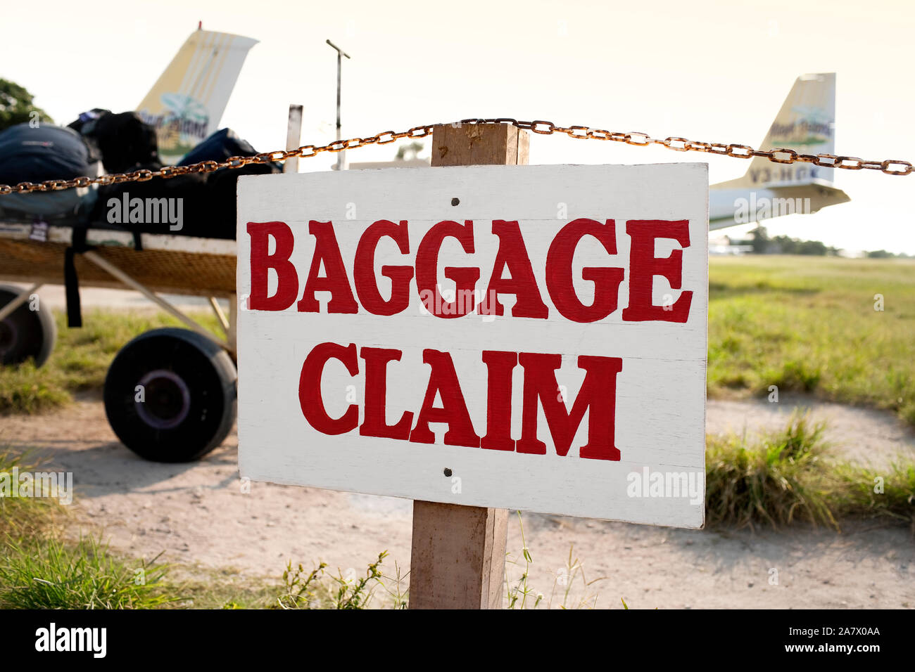 Baggage claim sign on the fence of a rural airstrip Stock Photo - Alamy