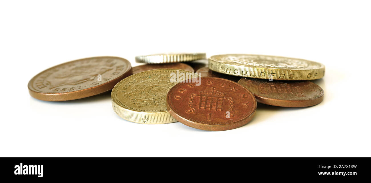 Small pile of British coins isolated on white background, closeup ...