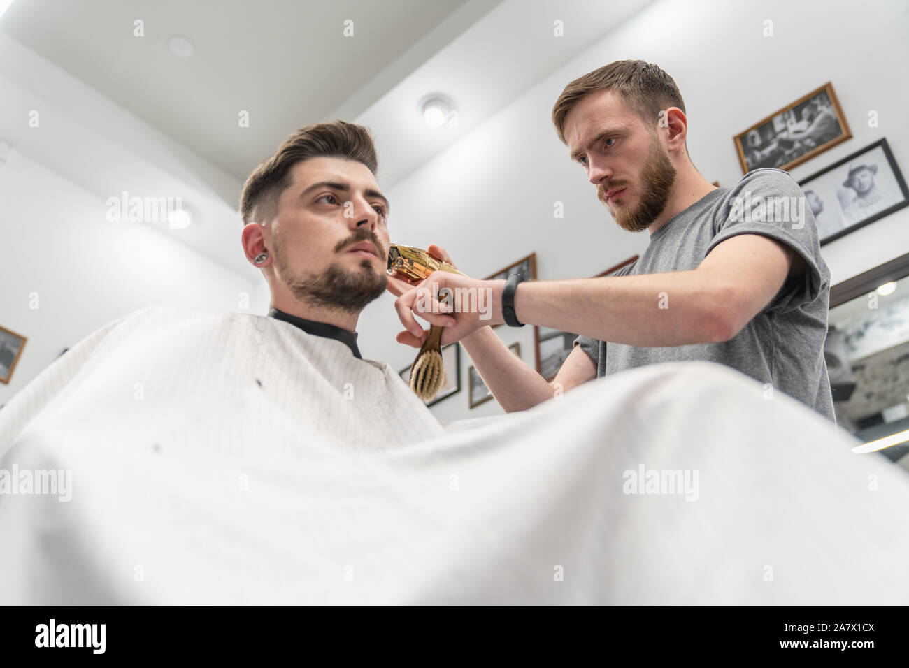 Barber making hairstyle confident hi-res stock photography and images ...