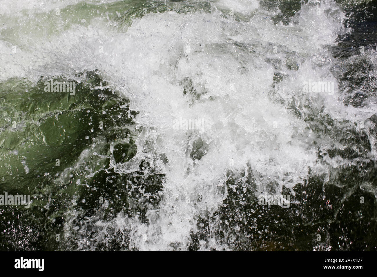 Rushing water of a river through rugged terrain Stock Photo - Alamy
