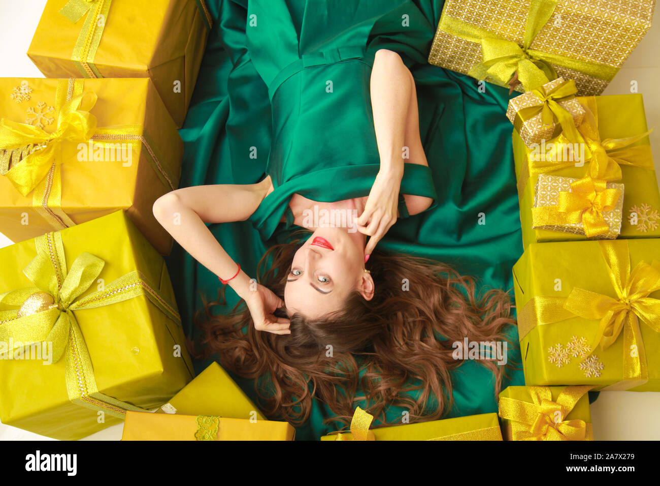 top view of beautiful slender fashion woman in trendy green dress lying ...