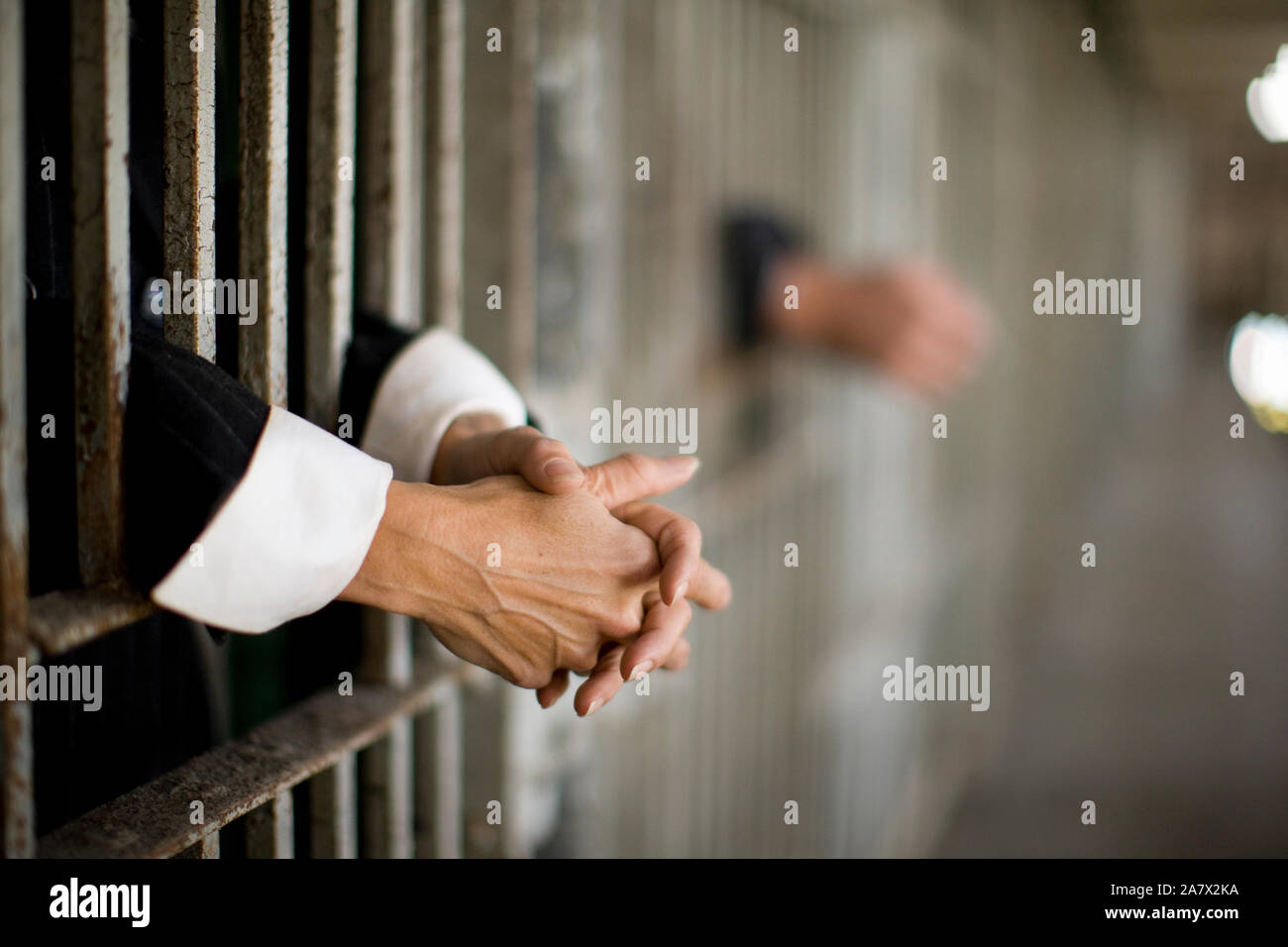 Hands through prison bars hi-res stock photography and images - Alamy