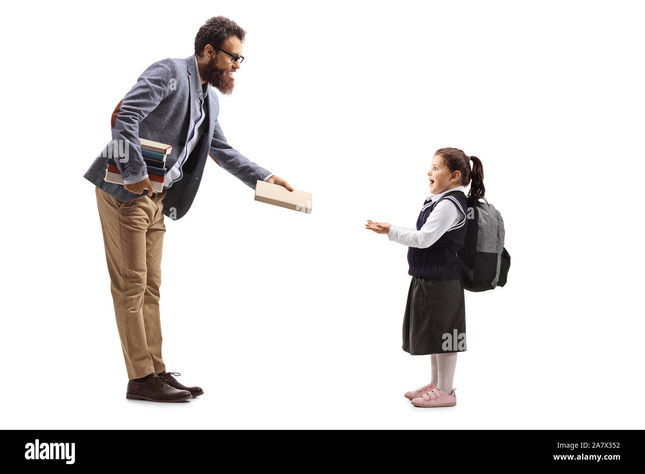 Full length profile shot of a man giving a book to a little schoolgirl ...