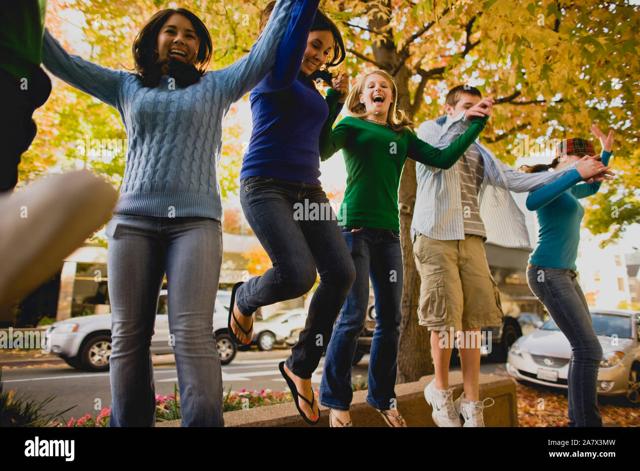 Friends jumping in the air Stock Photo - Alamy