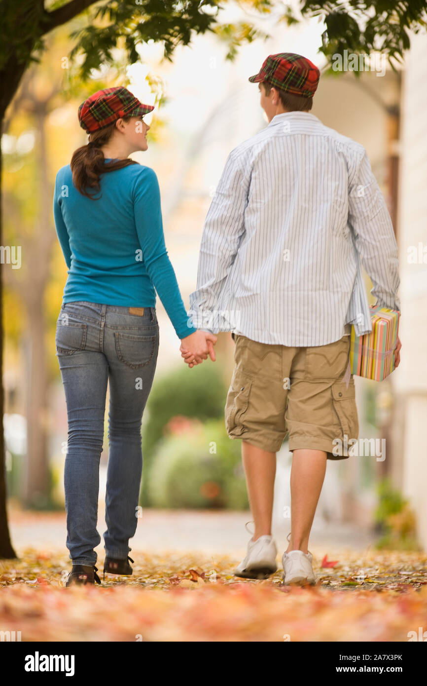 Teenage couple walking side by side Stock Photo - Alamy