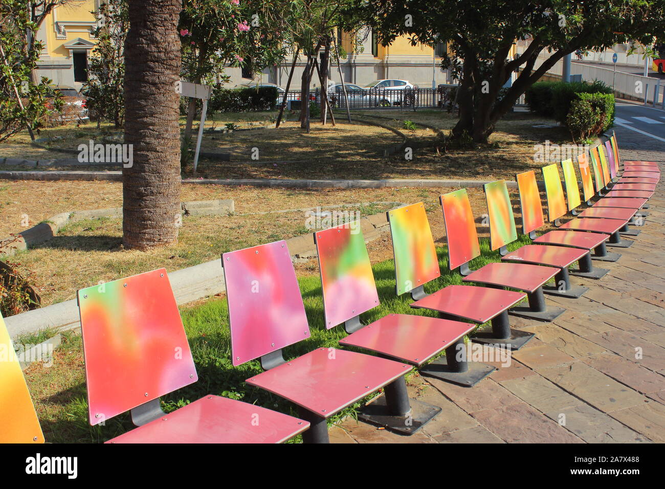 set of colorful benches during a beautiful day Stock Photo - Alamy