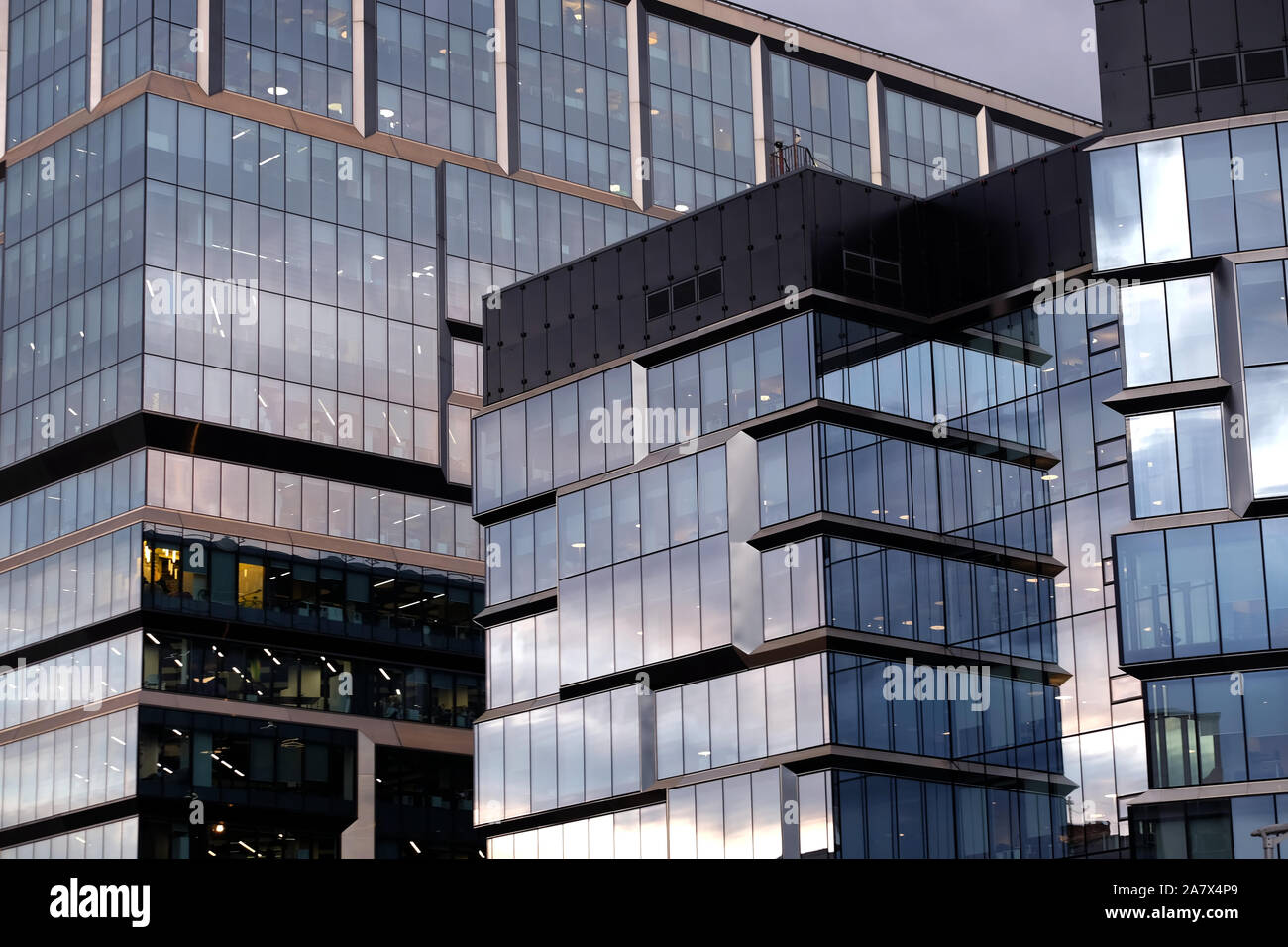 Facade with glass walls of modern office building cluster with many ...