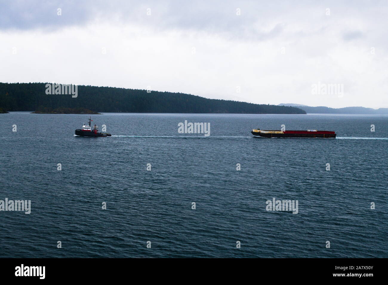 Tug boat towing a log barge in the Swanson Channel Stock Photo - Alamy