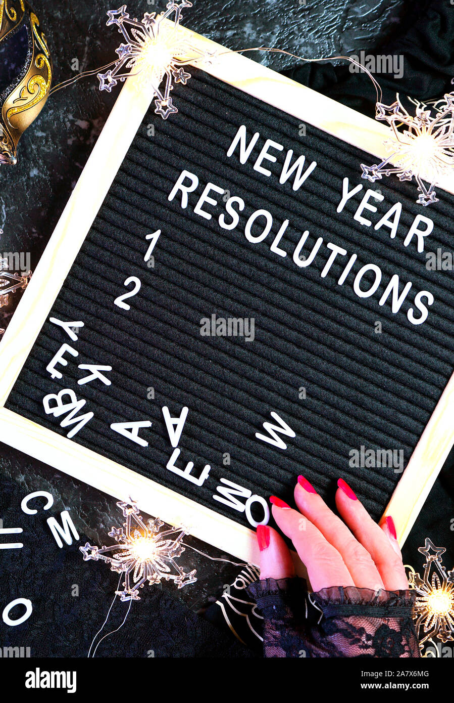 New Year's Eve resolutions flatlay with letter board and black and gold ...
