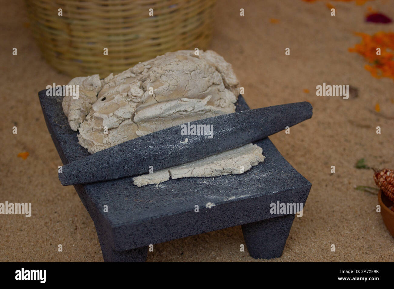 a handmade stone metate, with dough ready for making tortillas ...