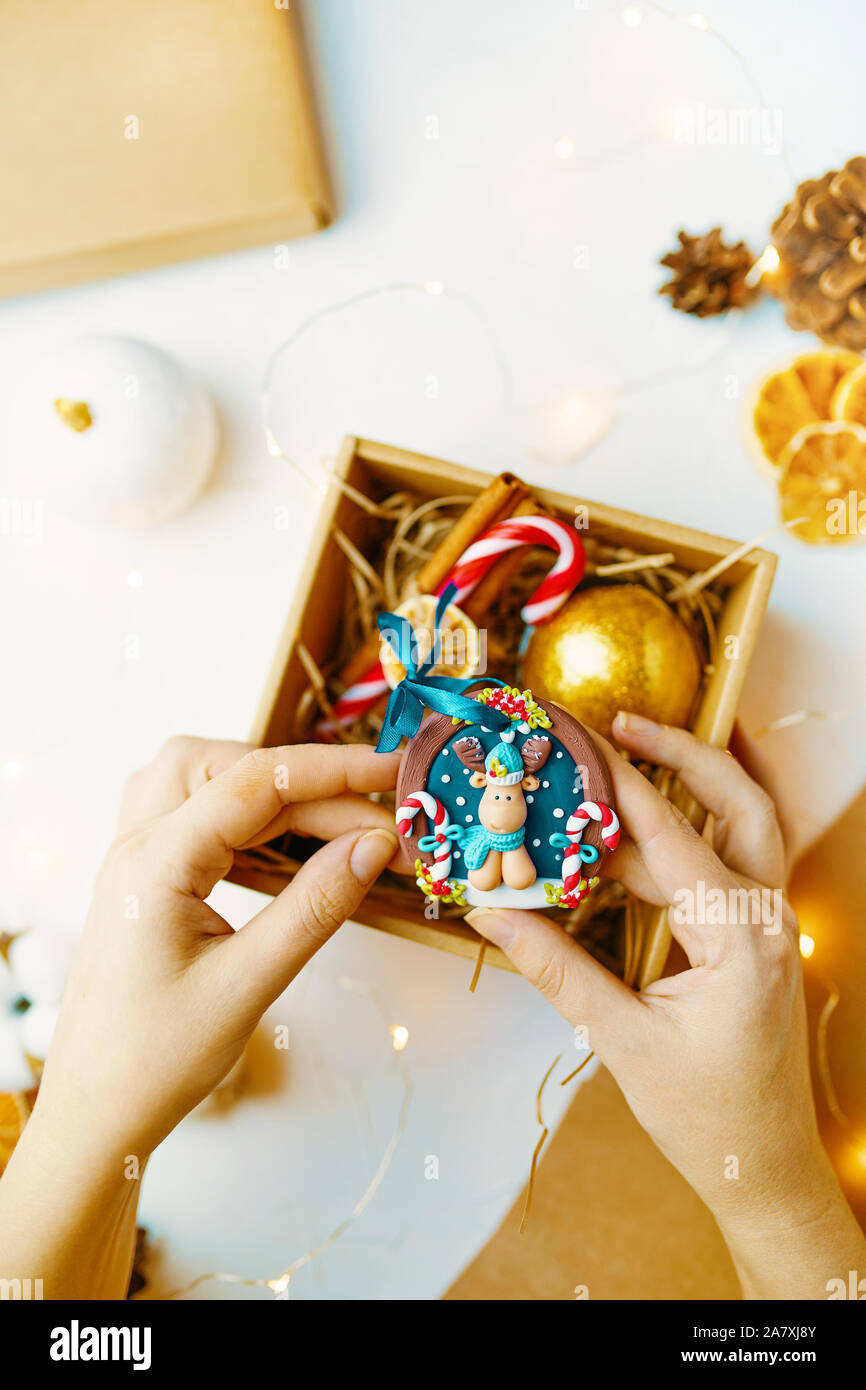 Process of packing gifts for holidays. Woman puts sweets in a box for ...