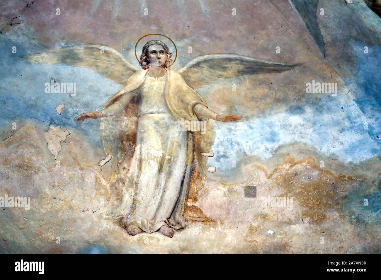Photo of an ancient fresco of an angel with wings on the wall of the ...