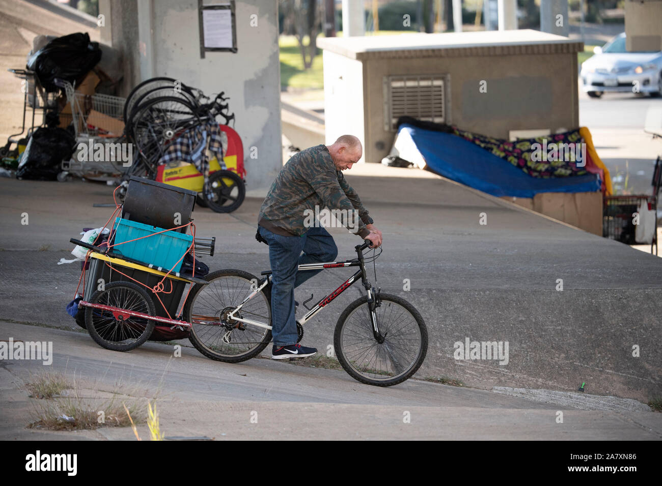 Homeless Texan leaves temporary encampment under highway overpass as ...
