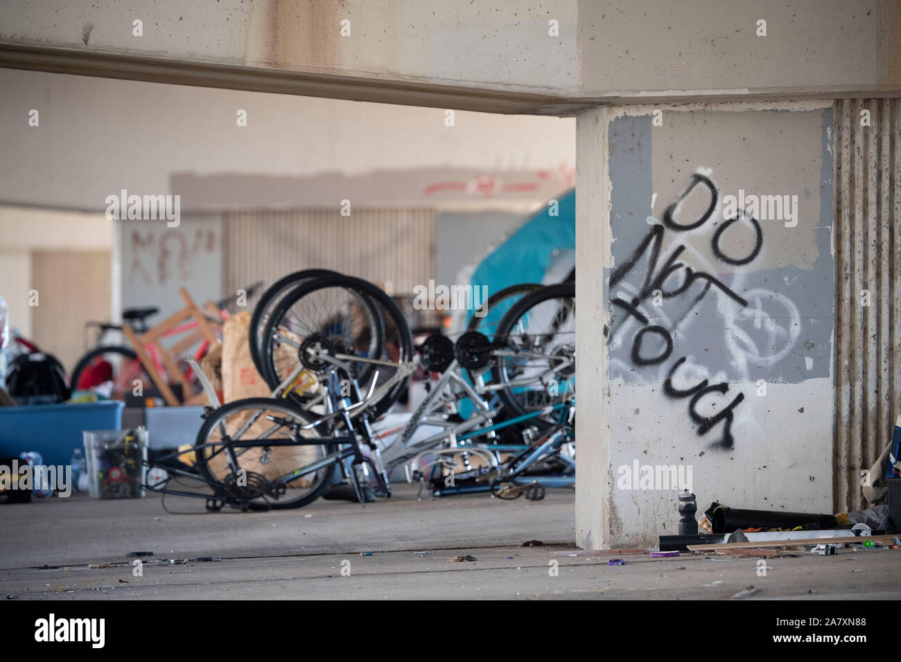 Debris and belongings litter a homeless camp in the public right-of-way ...