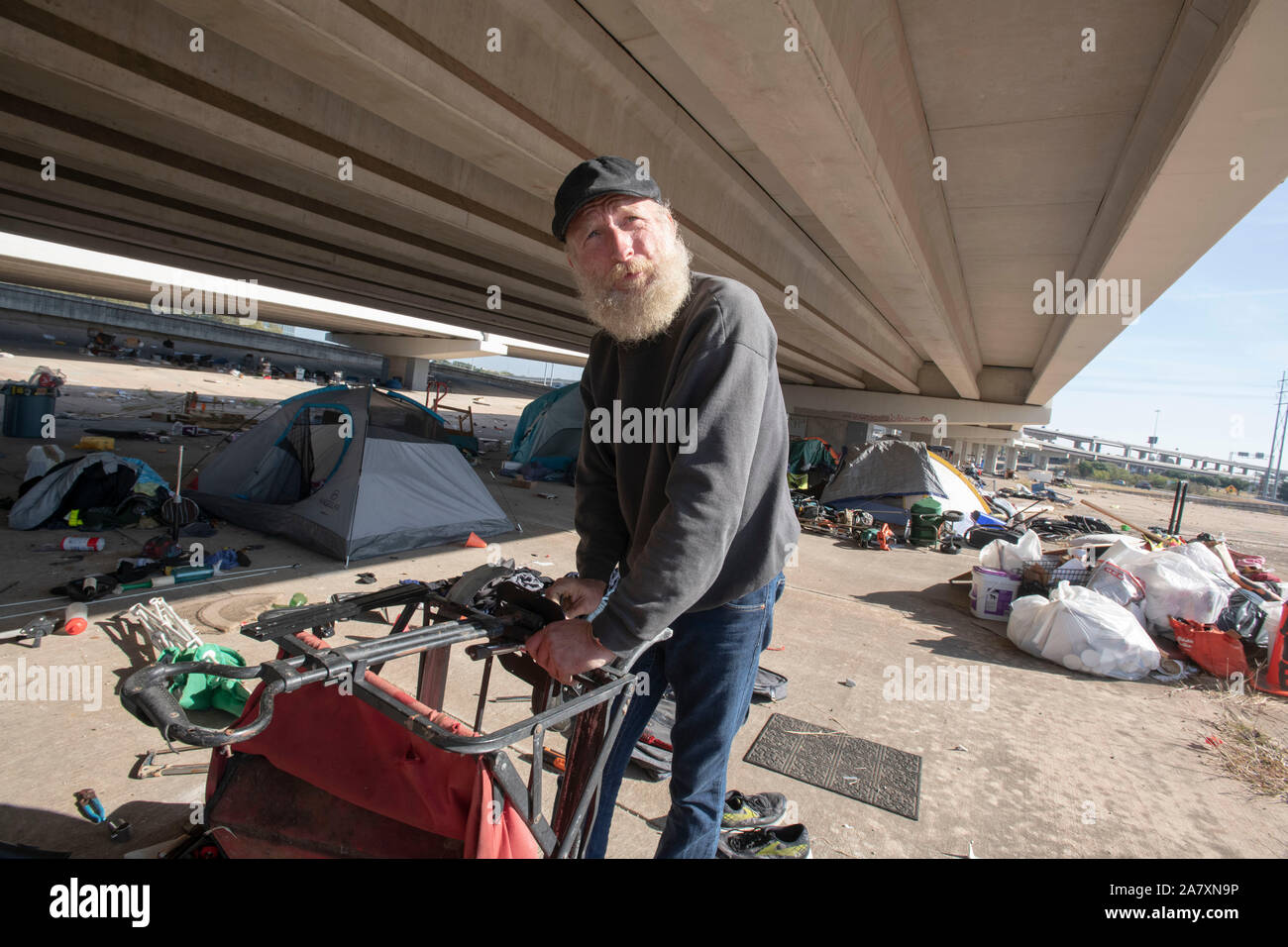 Homeless Texan leaves temporary encampment under highway overpass as ...
