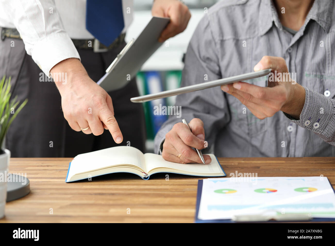 Two business male persons solving document problem Stock Photo - Alamy