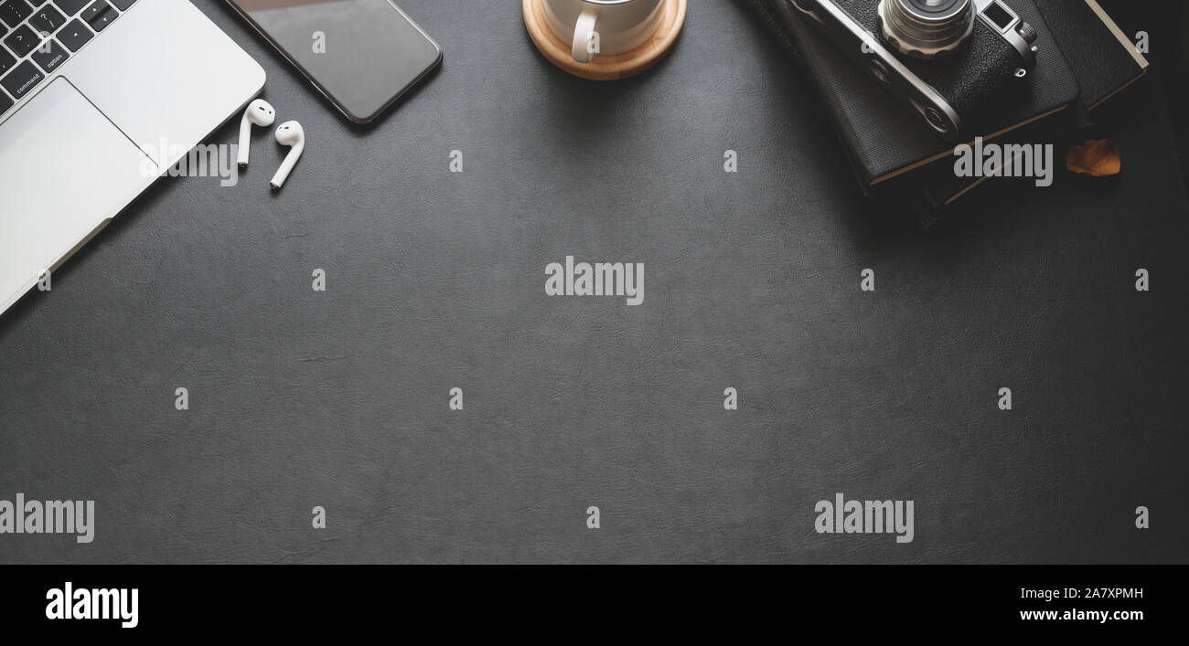 Overhead shot of dark modern workspace with copy space and office ...