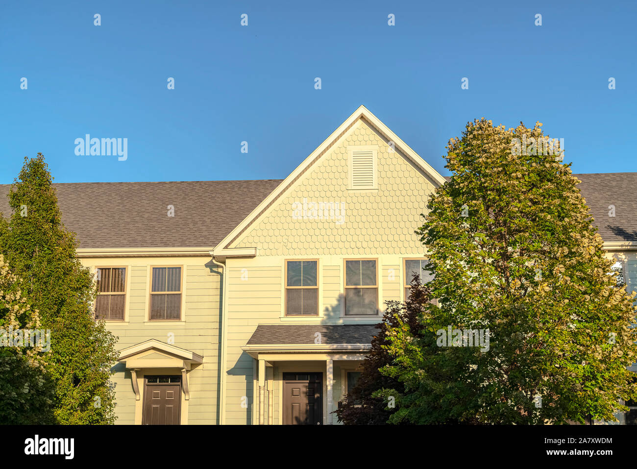 Facade of a large yellow house in evening light Stock Photo - Alamy