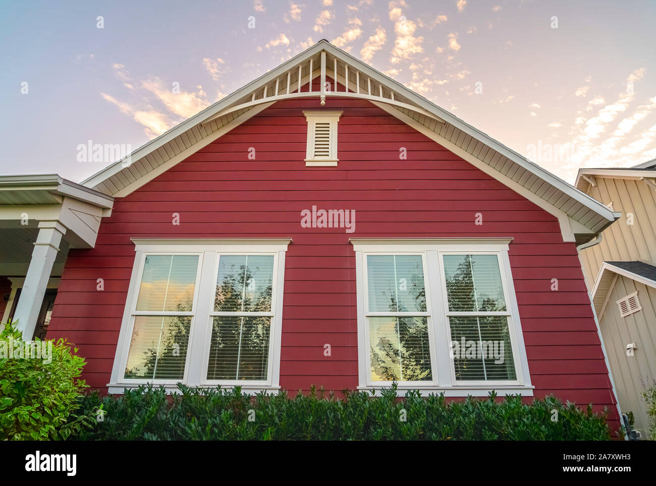 Colorful red timber clad house in day Stock Photo - Alamy