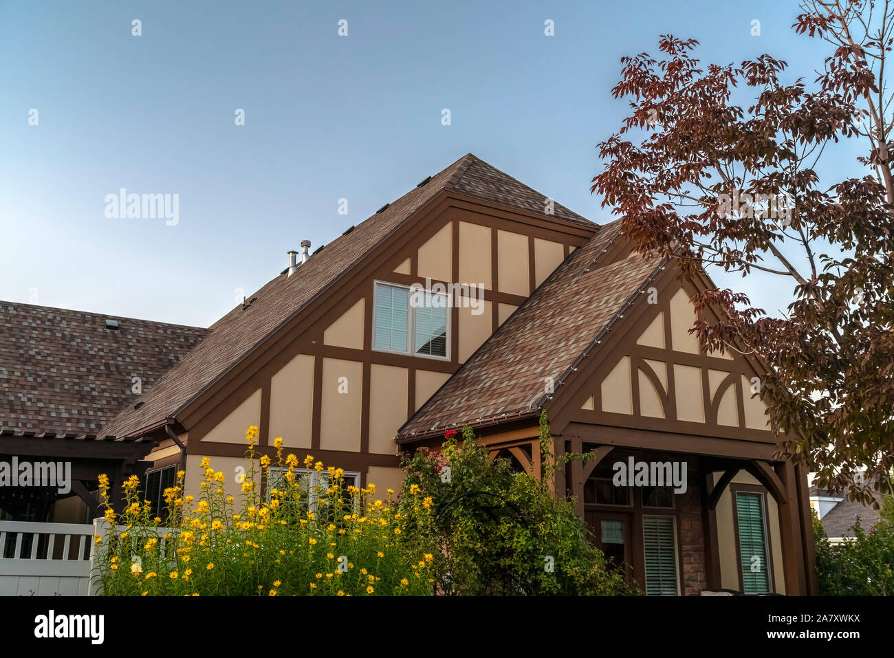 Unusual timber frame house with double apex roof Stock Photo - Alamy