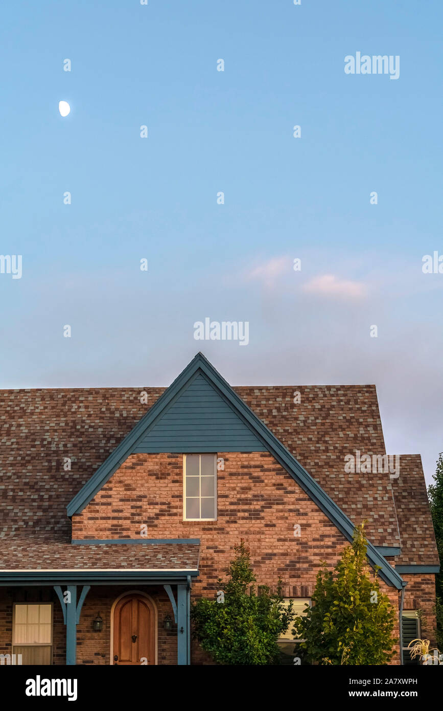 Face brick house with a steeply pitched roof Stock Photo - Alamy
