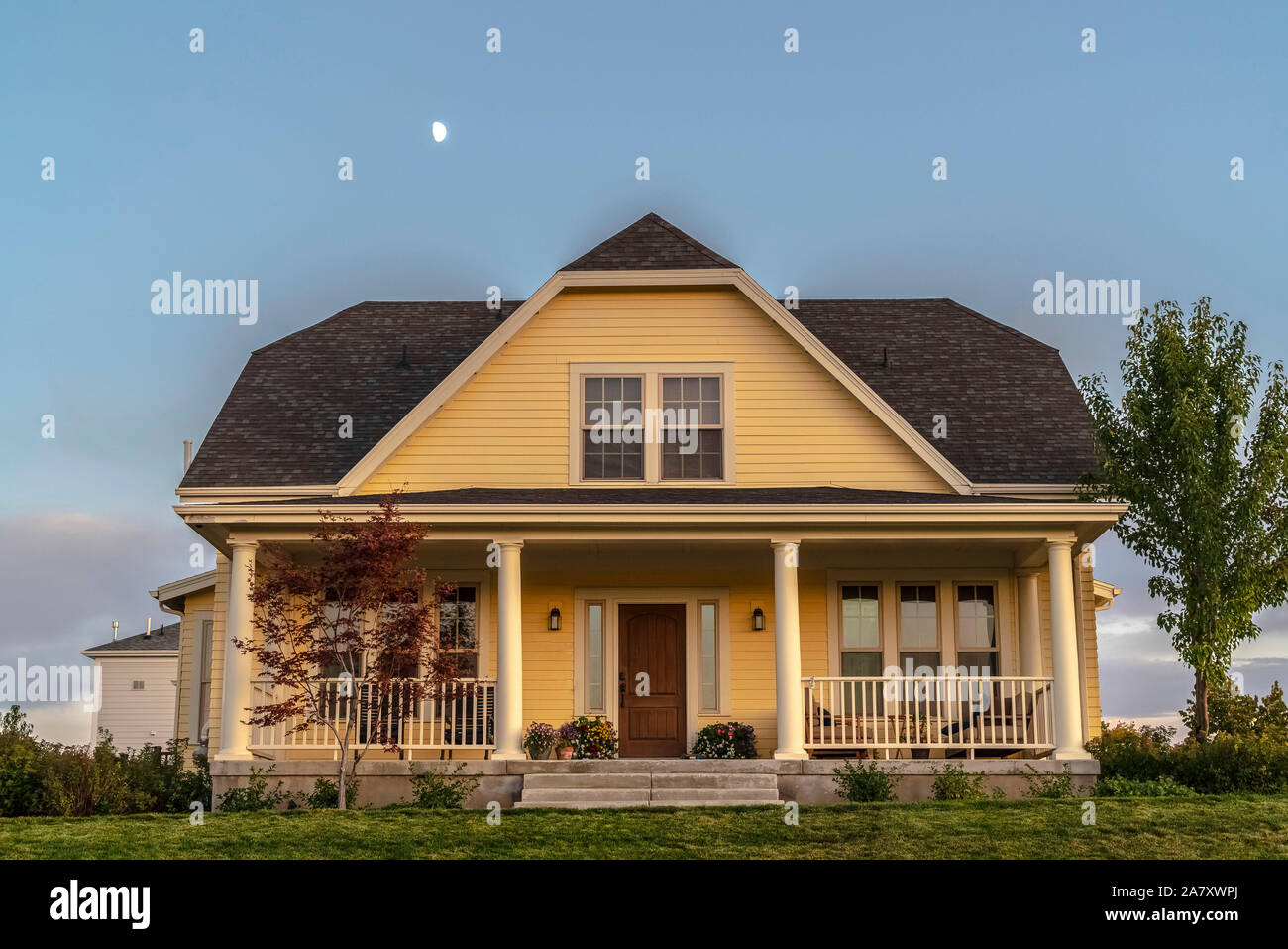Traditional double storey timber clad yellow house Stock Photo - Alamy
