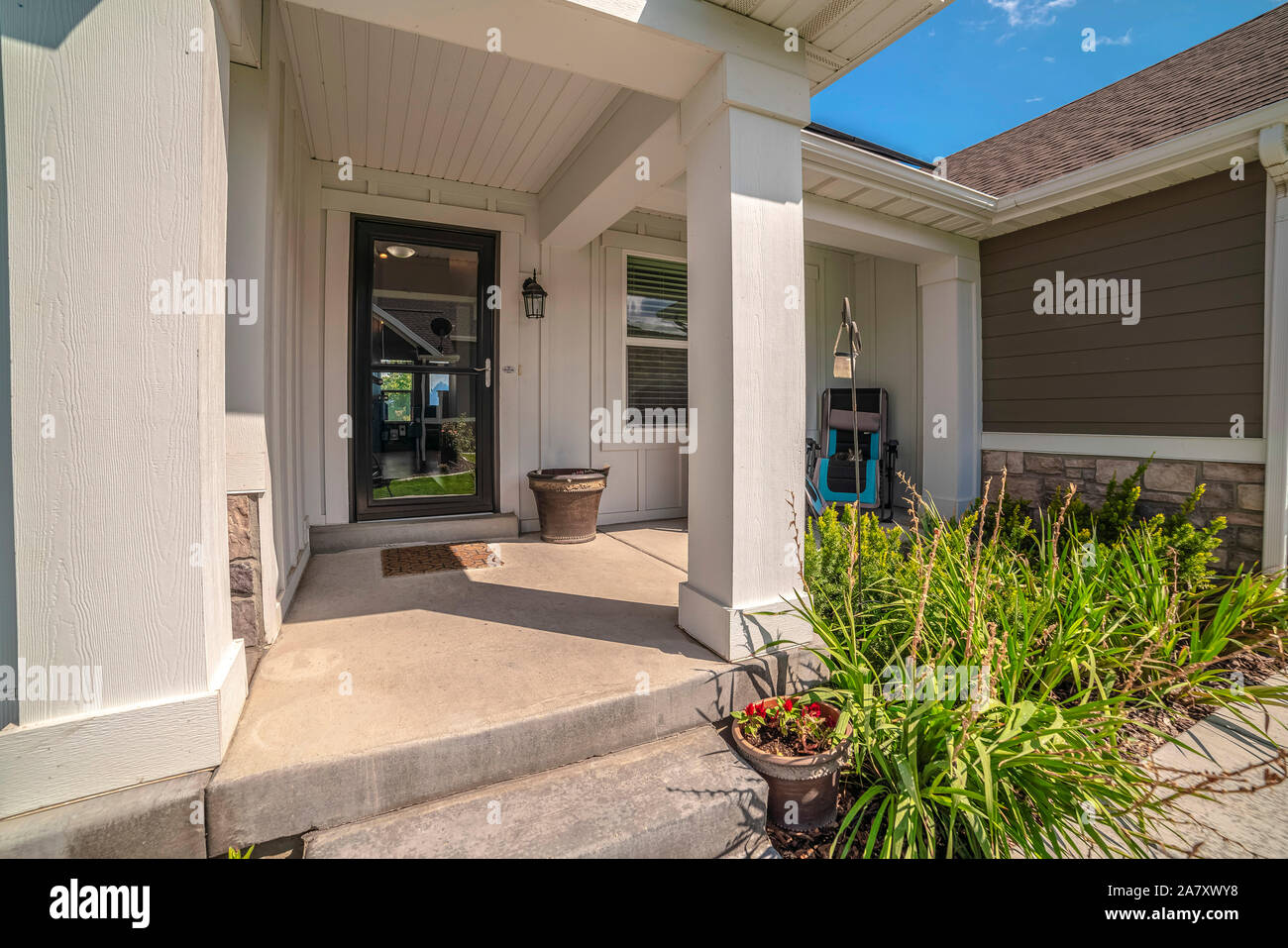 Covered porch and glass entrance door to a house Stock Photo - Alamy