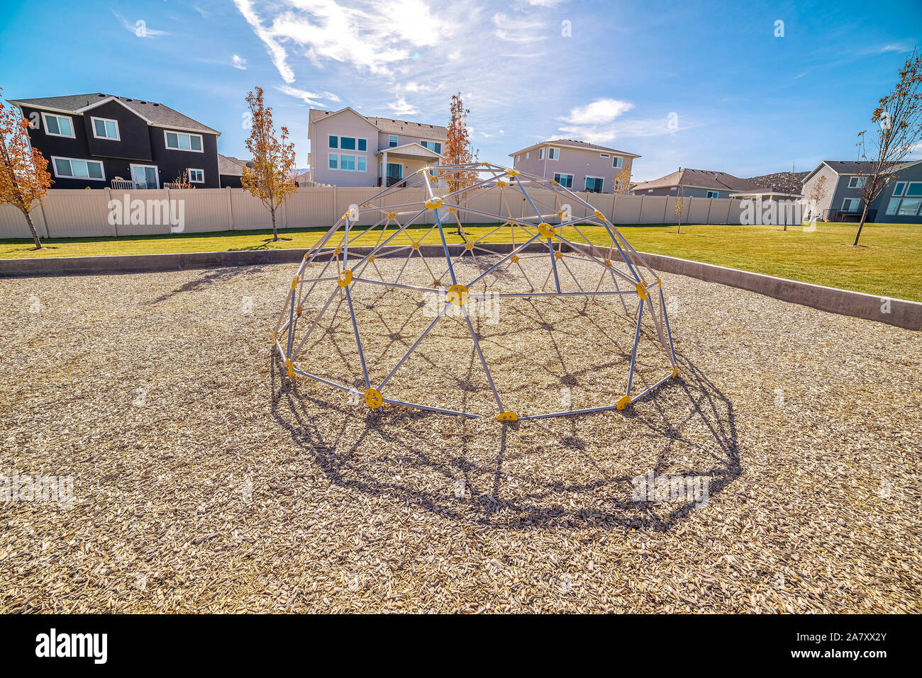 Kids climbing dome in an urban playground Stock Photo - Alamy