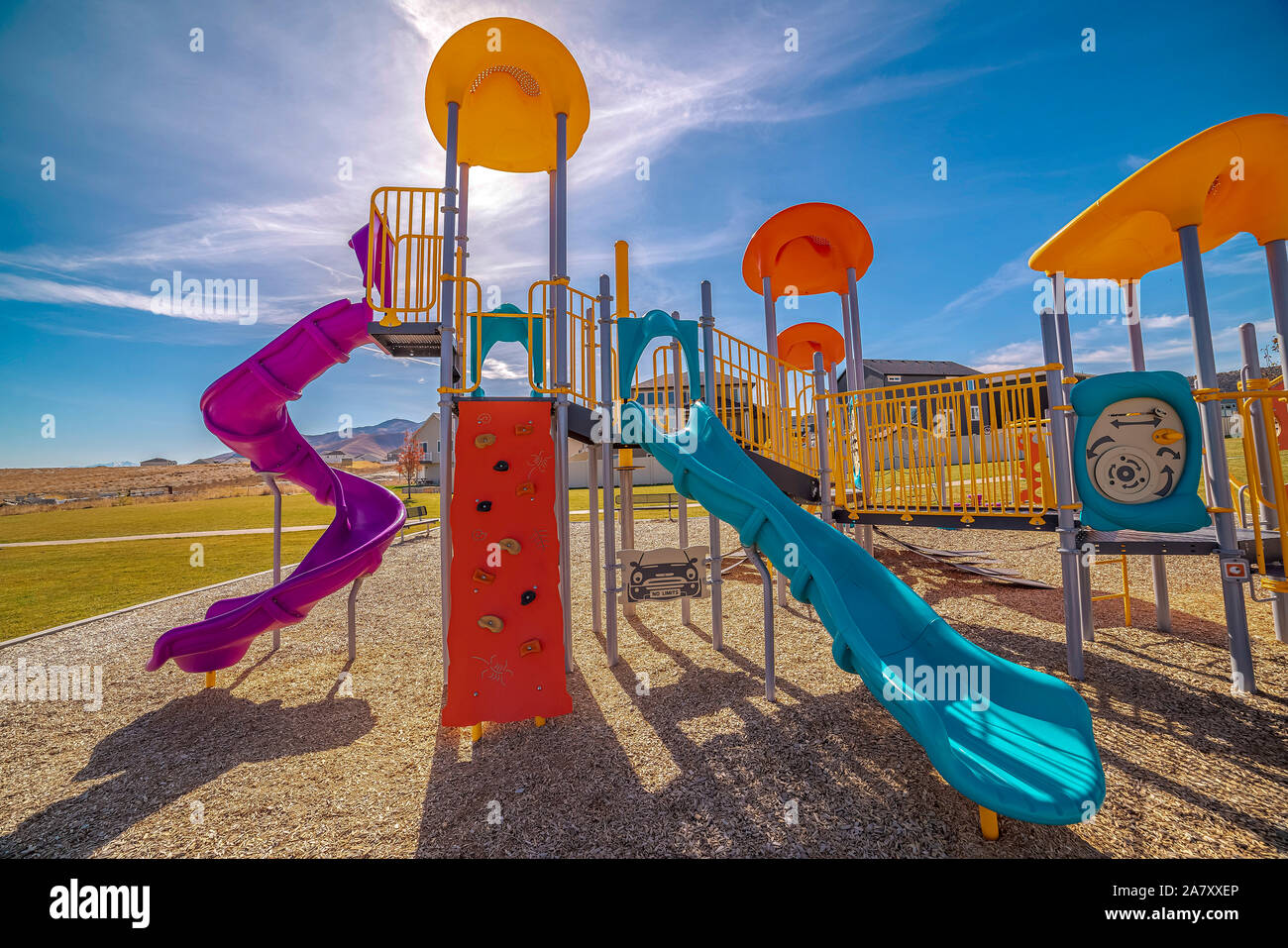 Colorful slides and equipment on a playground Stock Photo - Alamy