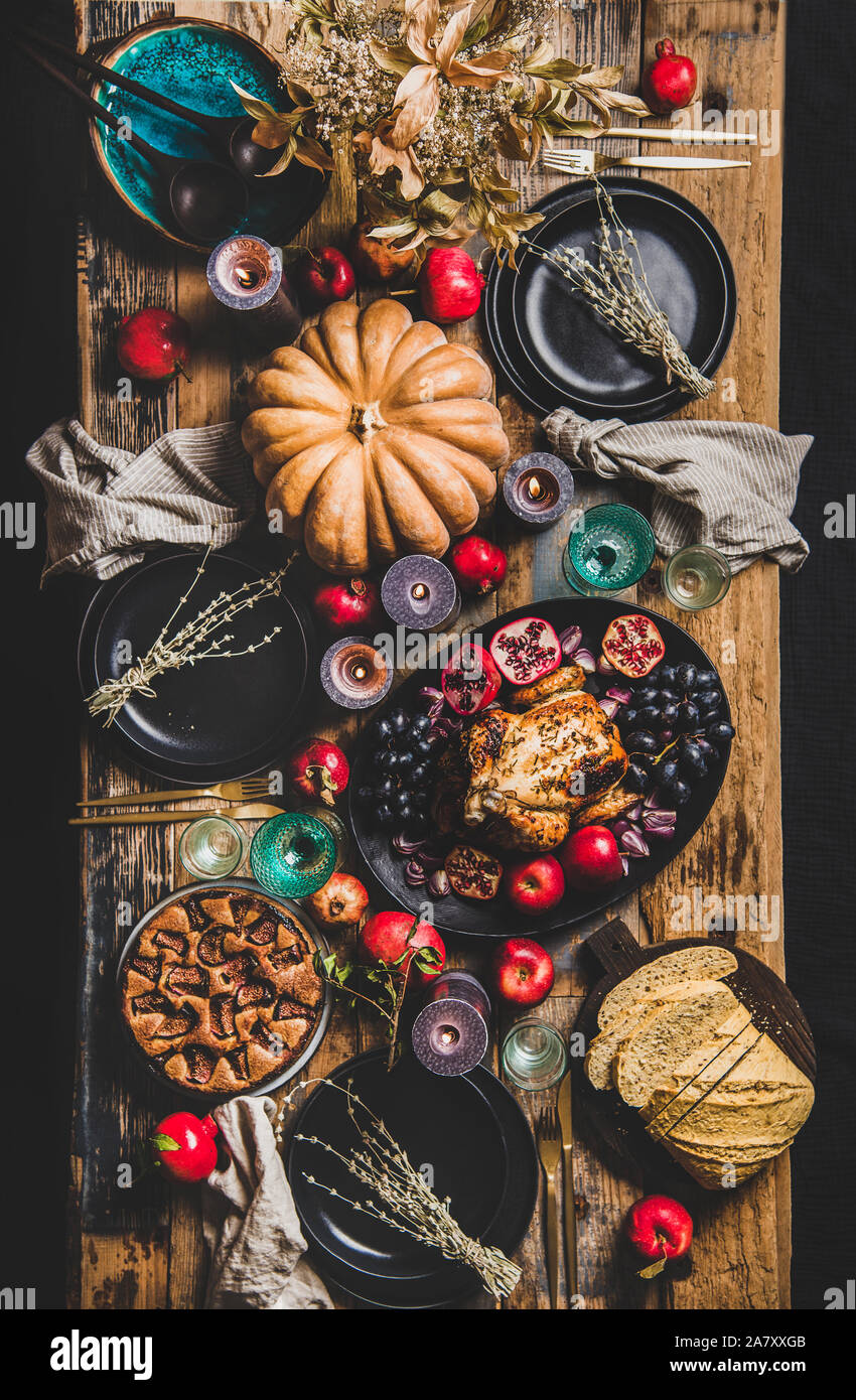 Thanksgiving party table setting with roasted chicken and seasonal ...