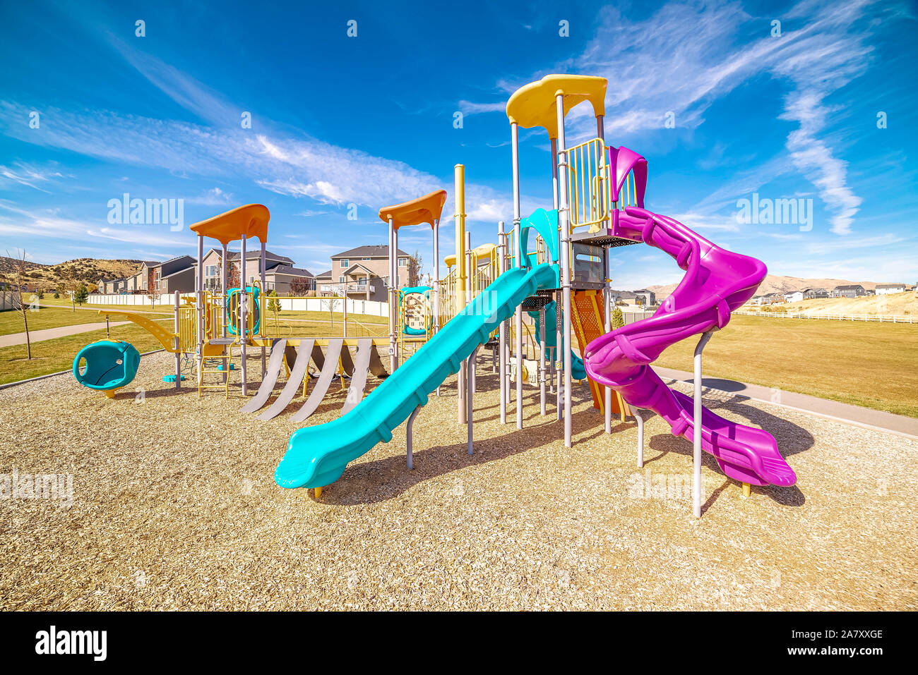 Colorful blue and purple slides in kids playground Stock Photo - Alamy