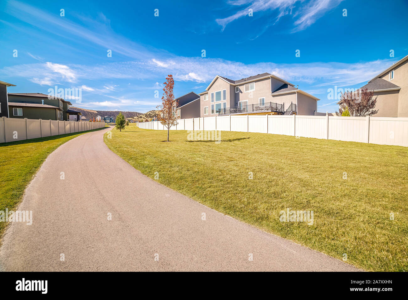 Curving pedestrian walkway in a greenbelt area Stock Photo - Alamy