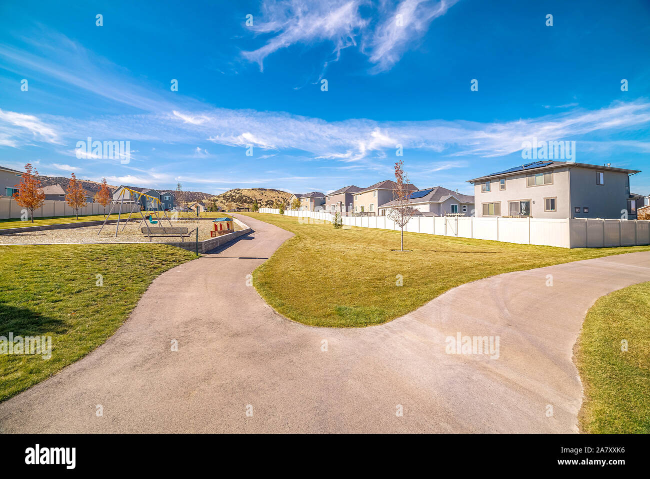 Forked paved pedestrian walkway in a park Stock Photo - Alamy