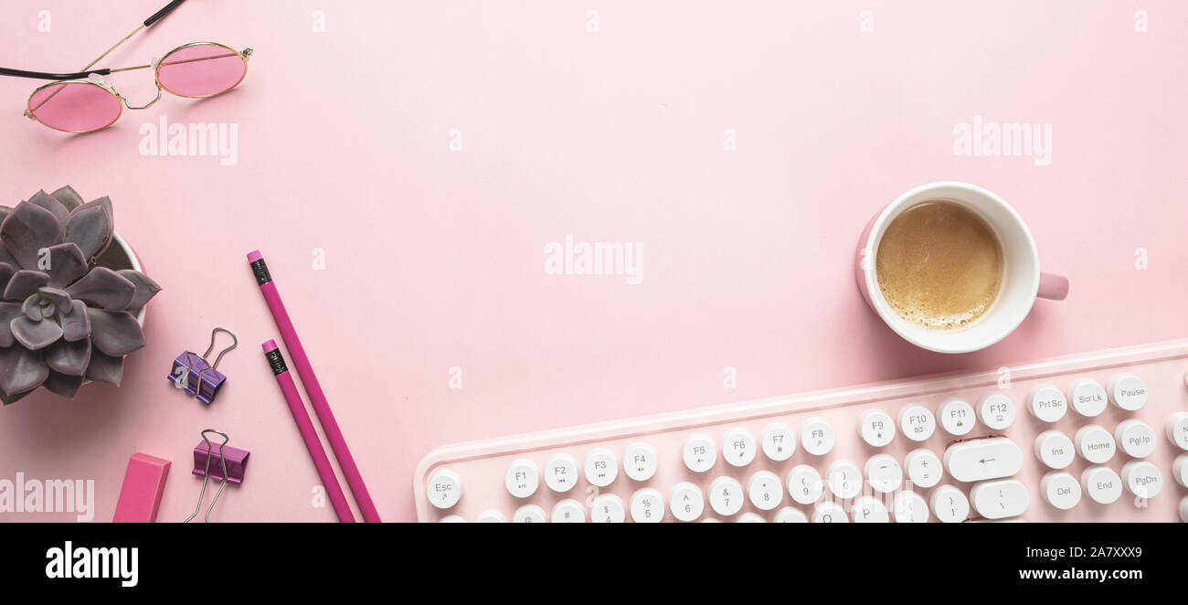 Woman office desk. Computer keyboard and stationery against pink ...