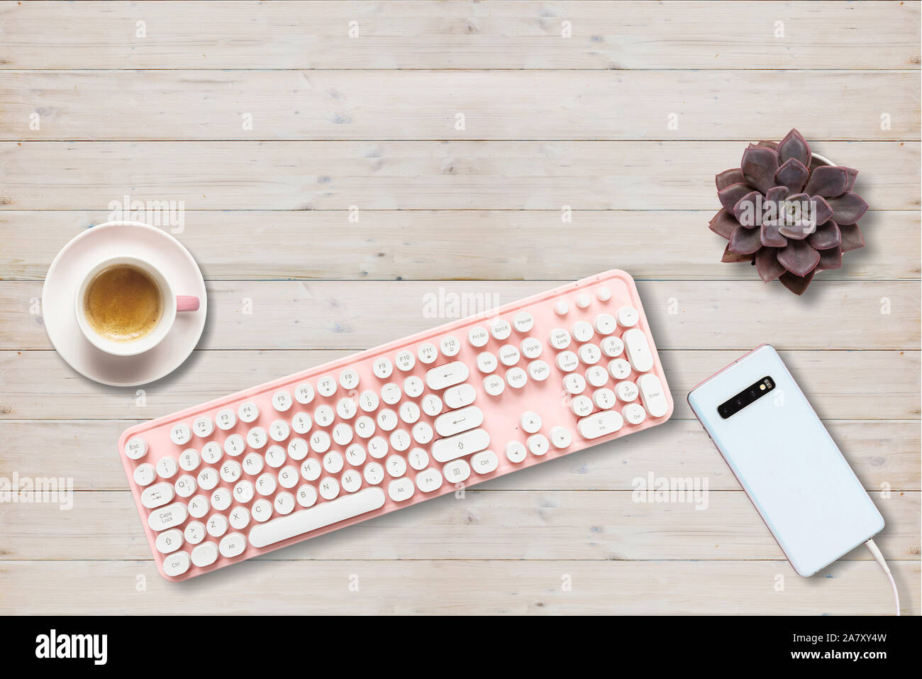 Female office desk. Computer keyboard pink color and mobile phone ...