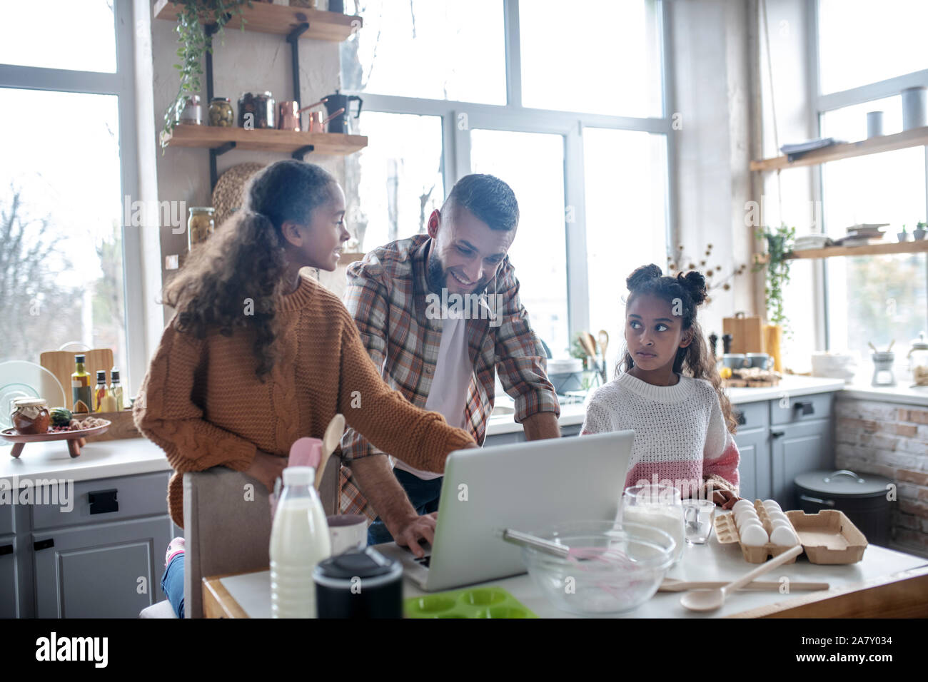 Daddy feeling excited before cooking pie with children Stock Photo - Alamy