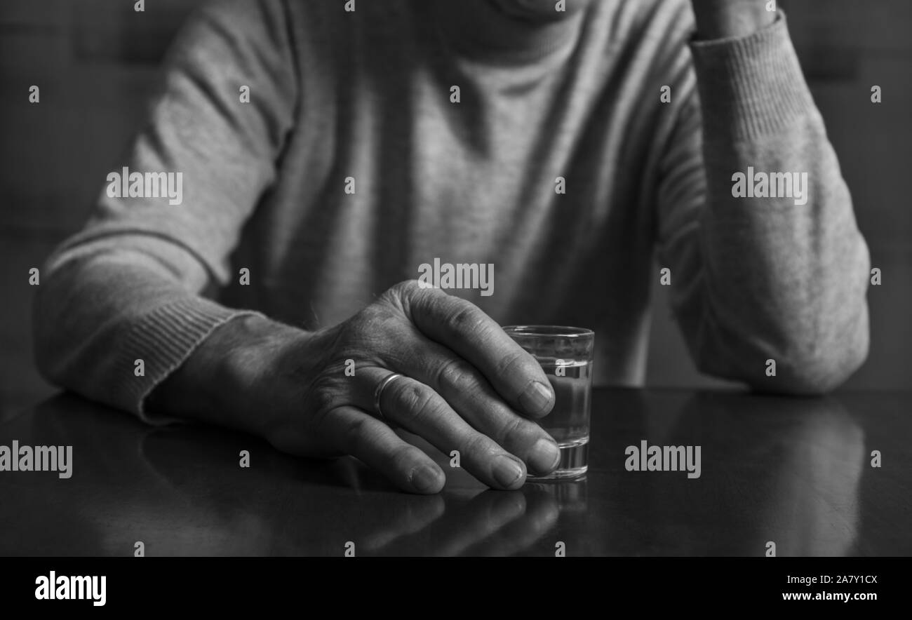 Man holding glass alcoholic drink Black and White Stock Photos & Images ...